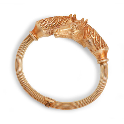 Bonhams : An 18ct gold horse-head bangle