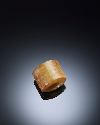 Bonhams : A green and russet jade inscribed archer's ring Qing Dynasty ...