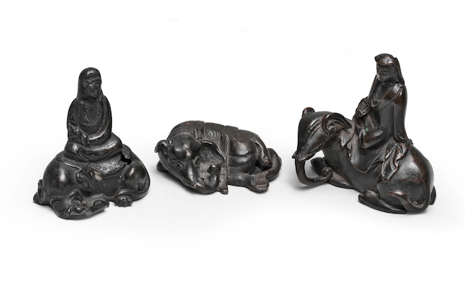 Bonhams : THREE BRONZE SCROLL WEIGHTS 16th/17th century (4)