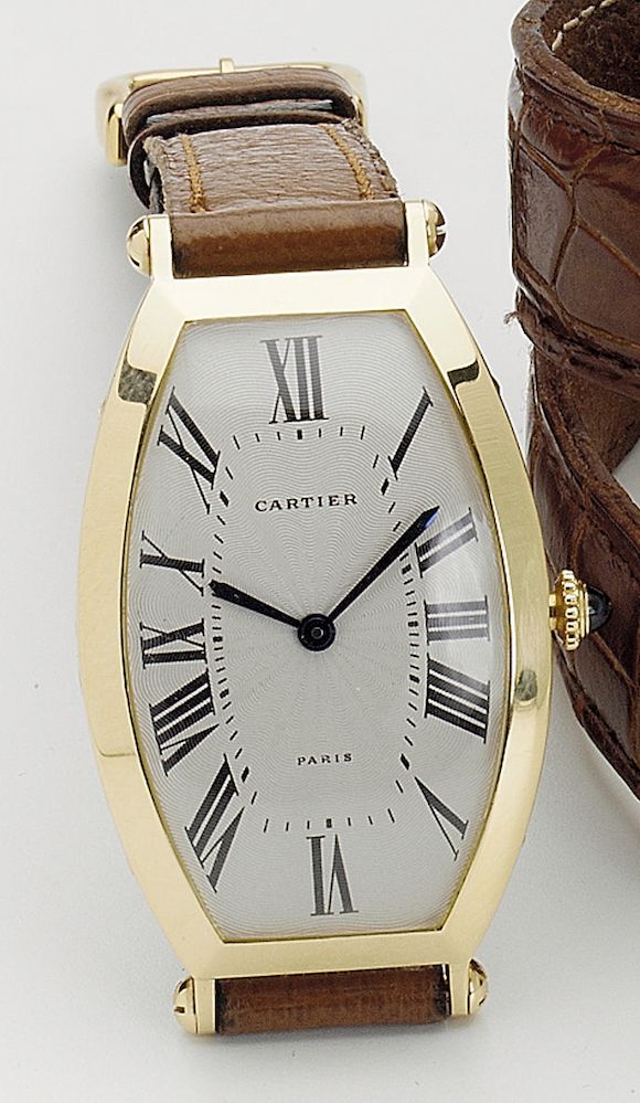 Bonhams : Cartier. A fine tonneau-shaped curved 18ct gold wristwatch ...