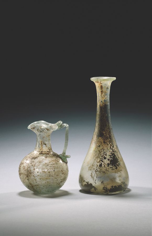 Bonhams : A Roman pale green glass carafe Circa 3rd Century A.D. and a ...