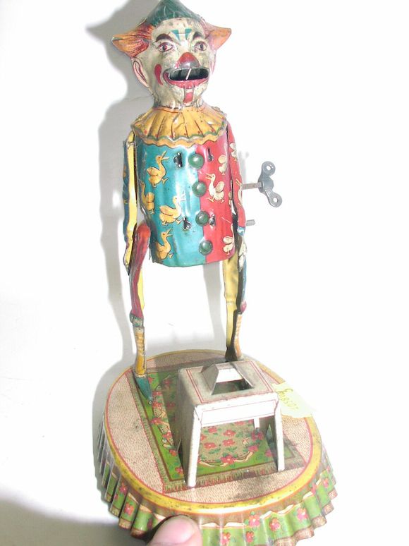 Bonhams : Tinplate Clown lifting Weight toy,