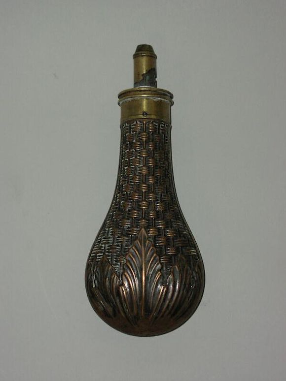 Bonhams : A copper powder flask,