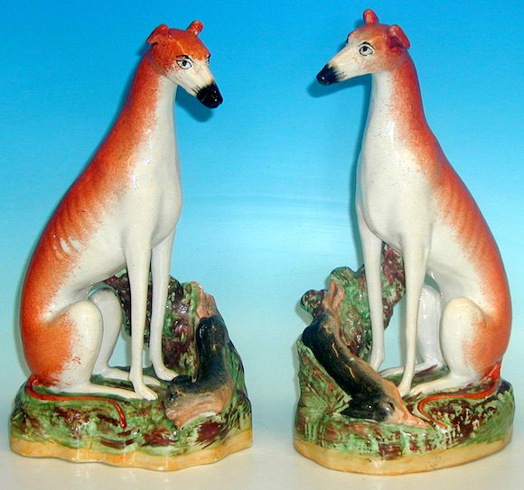 Bonhams : A pair of Staffordshire models of seated greyhounds,