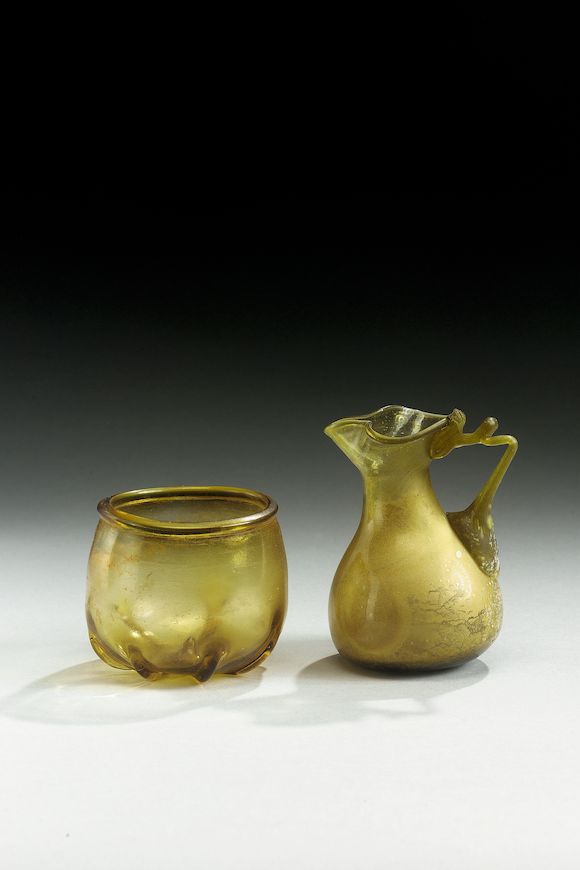 Bonhams : A Roman amber glass cup and an amber glass juglet (2)