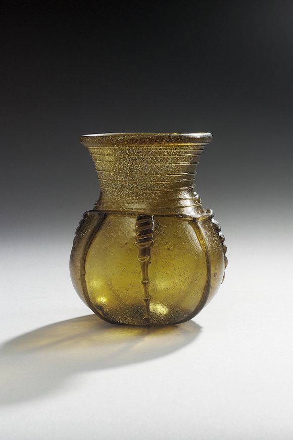 Bonhams : An Anglo-Saxon dark amber green glass globular beaker