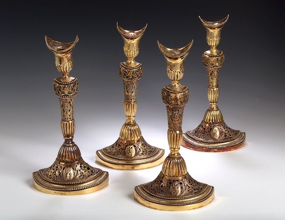 Bonhams : A set of four French silver gilt candlesticks,