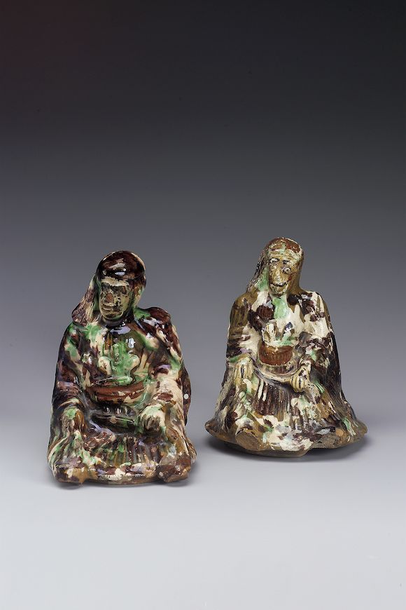 Bonhams : A pair of Chanakkale slip-painted pottery Figures Turkey ...
