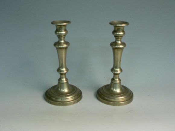 Bonhams : A pair of 19th century bell metal candlesticks