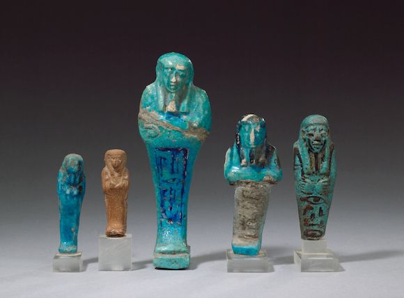 Bonhams : Four Egyptian bright blue glazed shabtis and a pottery shabti ...