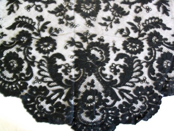 Bonhams : A black fascinator of imitation Blonde lace,
