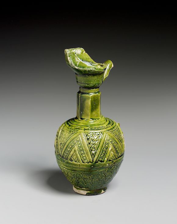 Bonhams : An early Islamic monochrome carved and moulded pottery Ewer ...