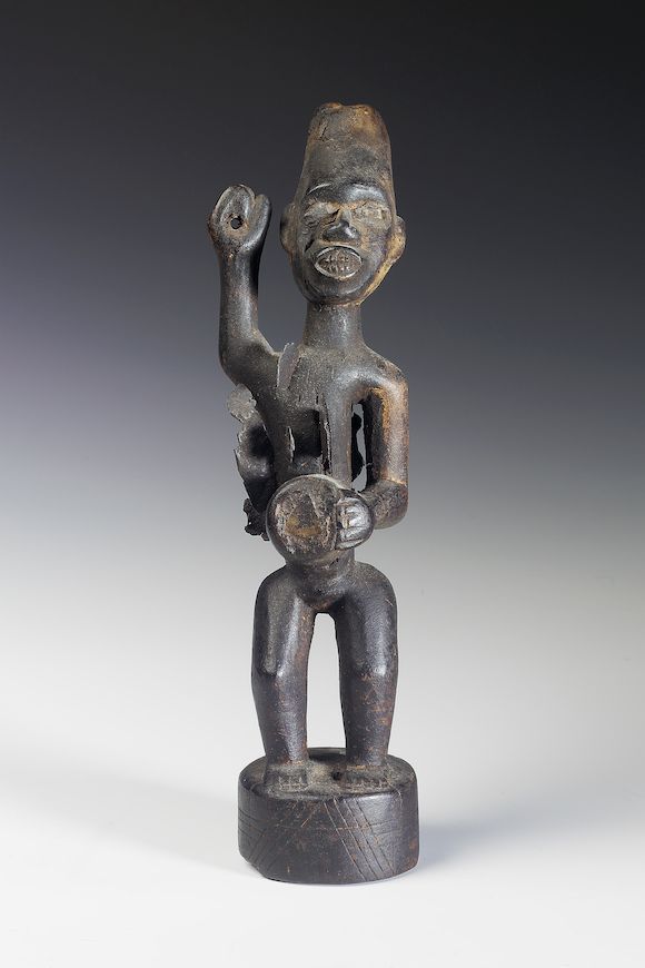 Bonhams : A Kongo wood fetish figure of a hunter 32cm.