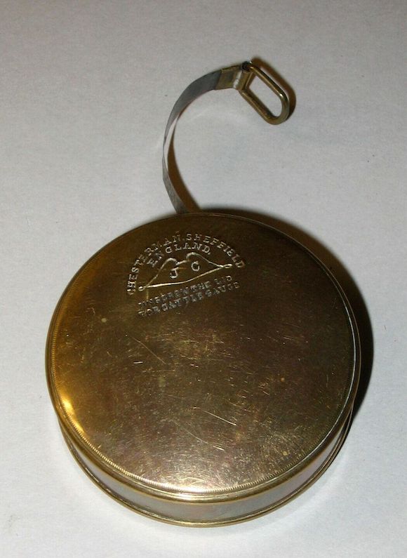Bonhams : A circular brass cased tape measure