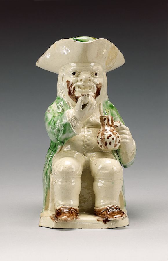 Bonhams : A creamware 'Step' Toby jug and a cover, circa 1780,