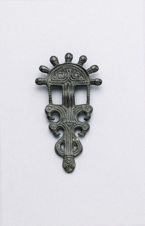 Bonhams : A Merovingian copper alloy radiate-headed bow brooch