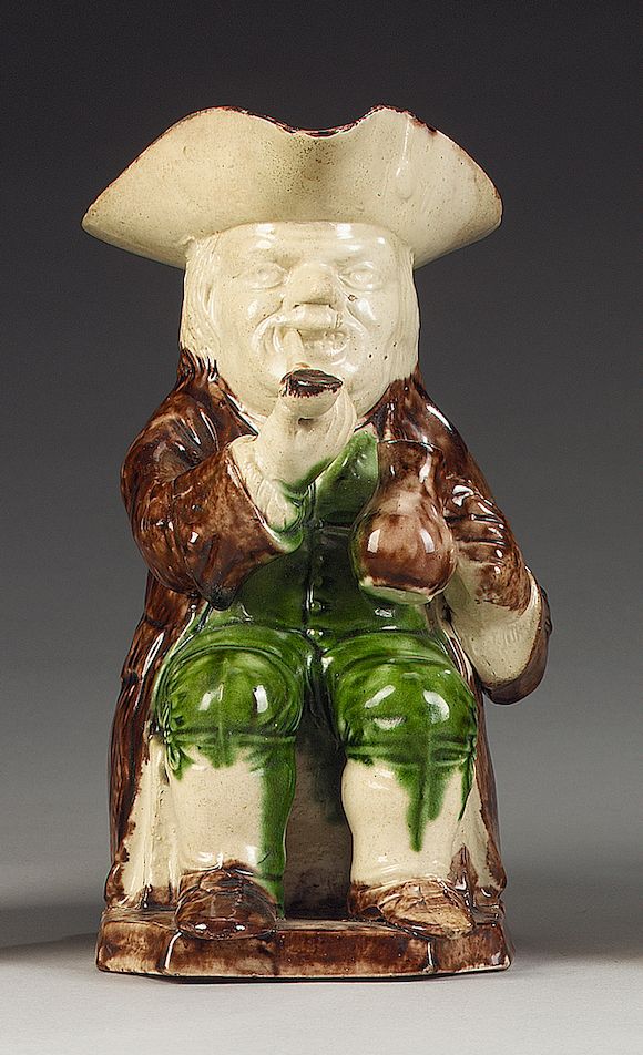 Bonhams : A Whieldon type creamware 'Step' Toby jug, circa 1780,