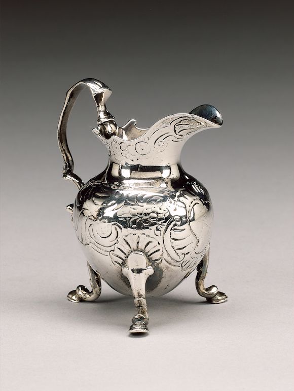Bonhams : A George II cast silver cream jug, maker's mark rubbed, London 1738,