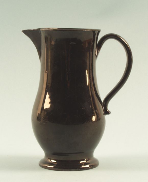 Bonhams : An 18th century black glazed Jackfield style jug