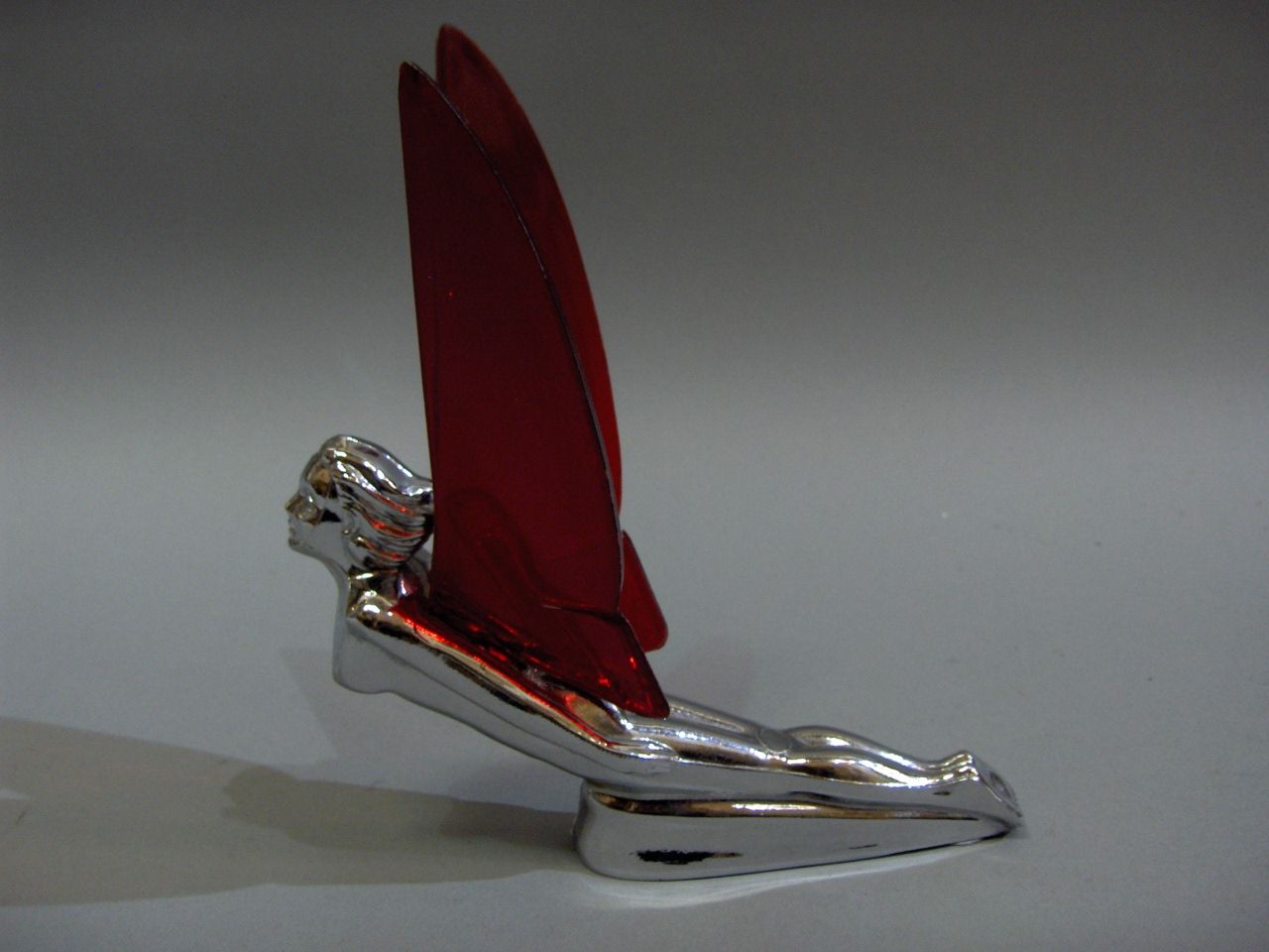 Bonhams Cars : An illuminated red winged goddess car mascot,