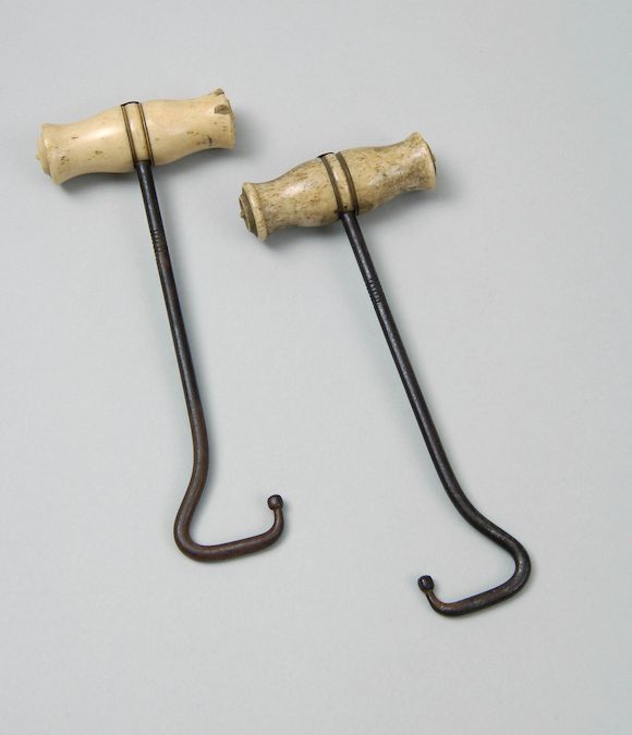 Bonhams : Two mid 19th century bone handled jockey's boot pulls,