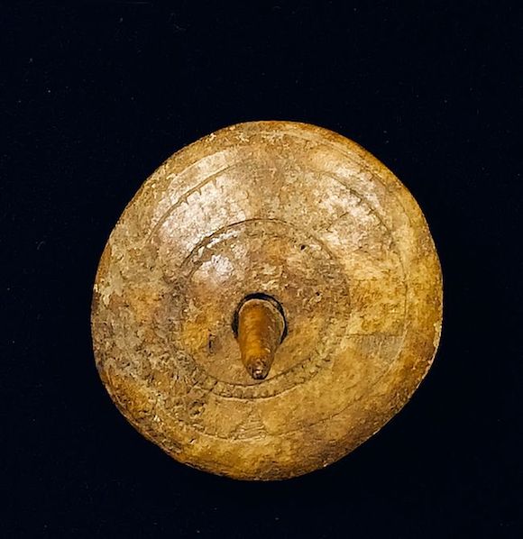 Bonhams : An Eskimo bone spinning top L.12.31 10.8 ? 6cm. diam.