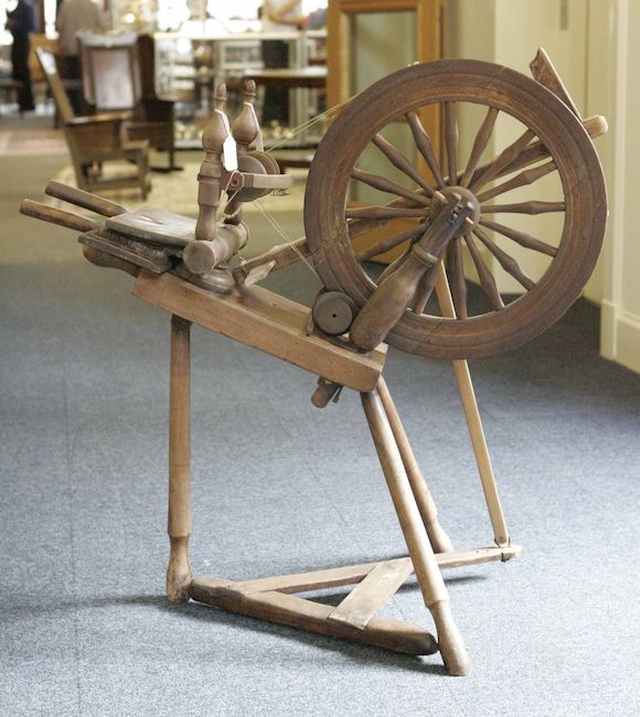 Bonhams : A beech and stained pine spinning wheel
