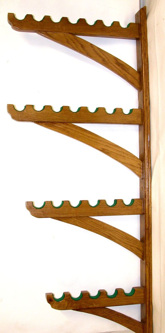 Bonhams : Four wall mounted graduated oak rod racks