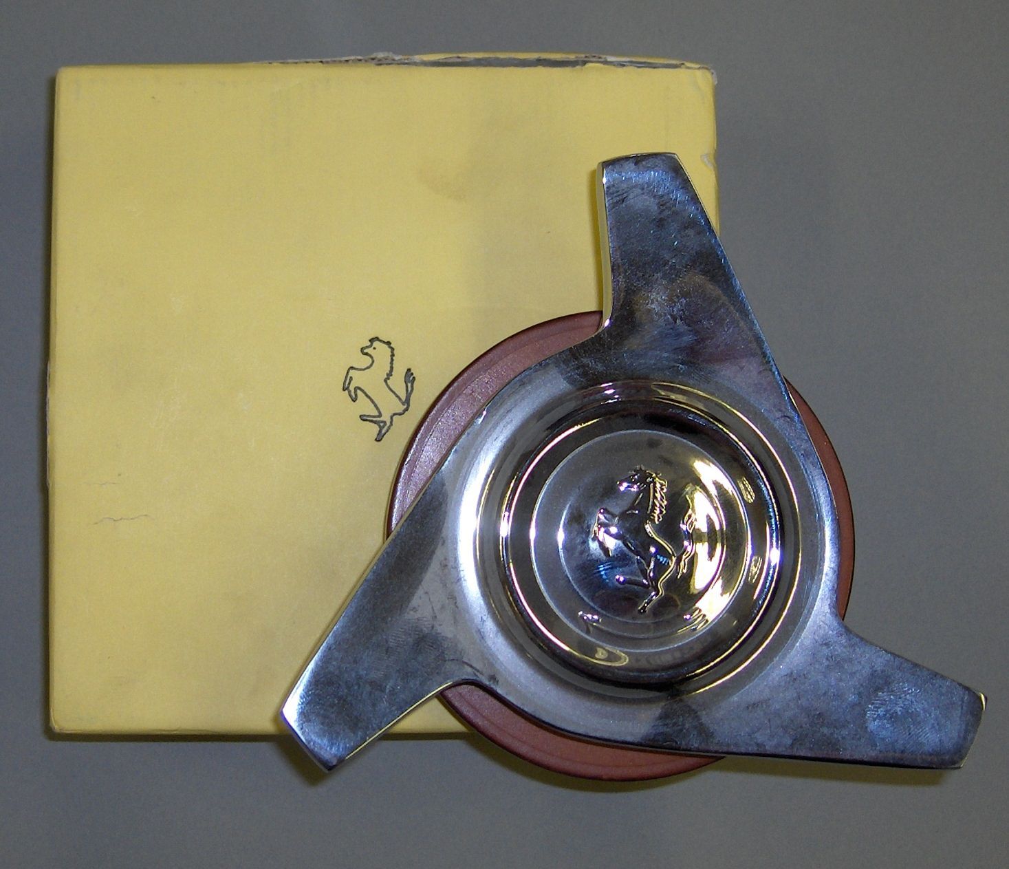 Bonhams Cars : A Ferrari wheel-hub paperweight, boxed,