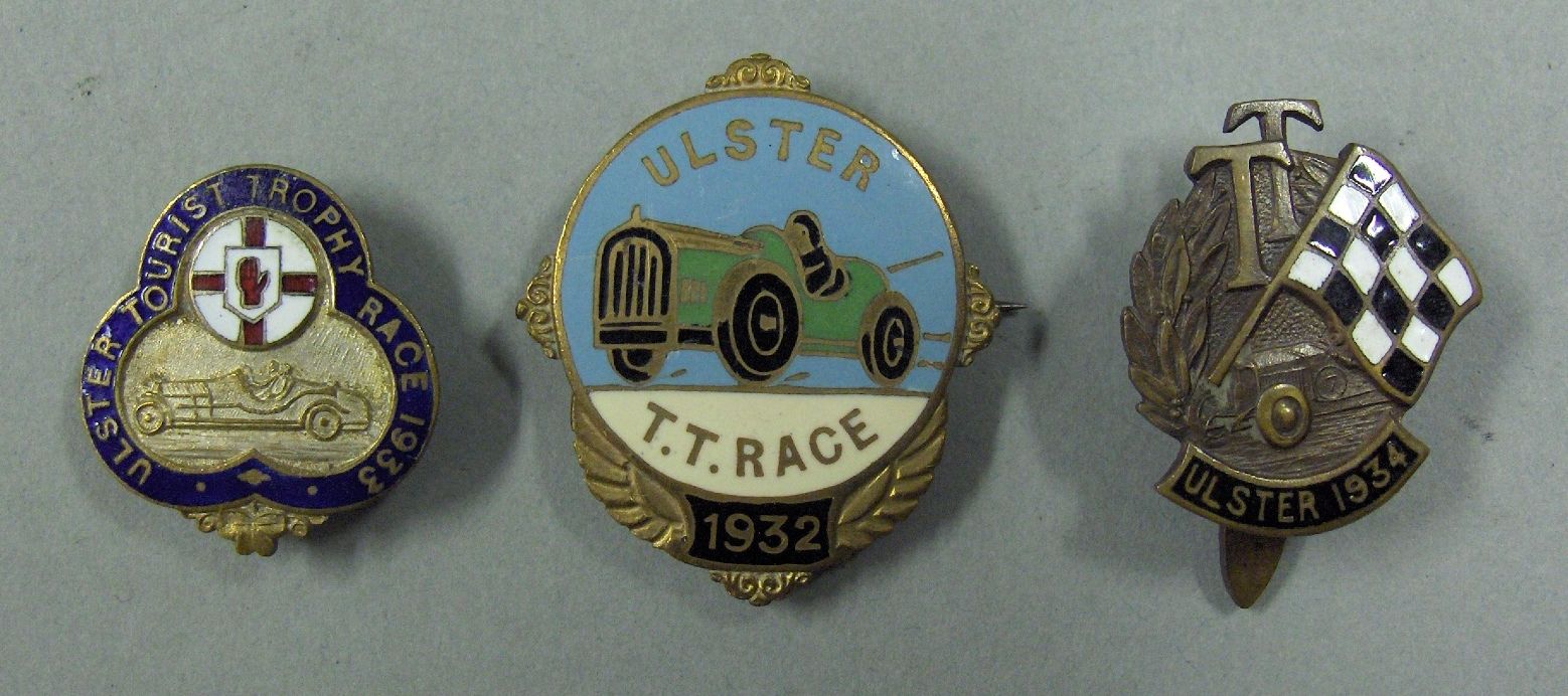 Bonhams Cars : Three Ulster Tourist Trophy Race enamel lapel badges, 1930s,
