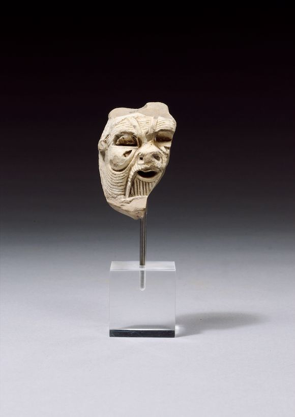 Bonhams : An Egyptian white glazed composition fragmentary Bes head