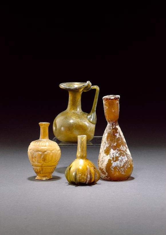 Bonhams : A Roman pale amber glass bottle a small Roman olive green ...