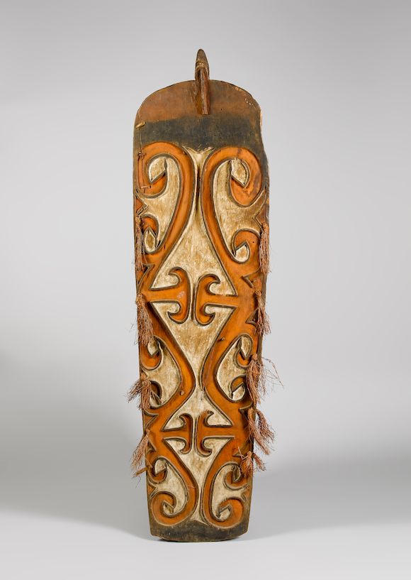 Bonhams : An Asmat shield and a Sepik food hook 43in (110cm) 2