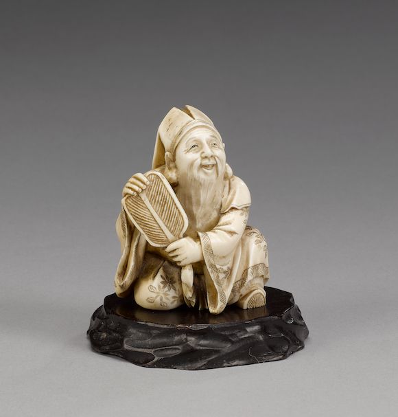 Bonhams : A small ivory okimono of Jurojin; wood stand