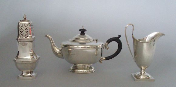 Bonhams : A silver helmet shaped cream jug, Chester 1933, a caster and ...