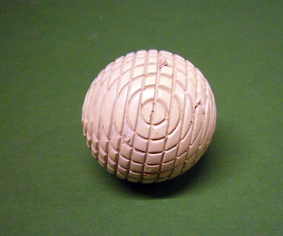 Bonhams : A medium sized well-detailed wooden golf ball