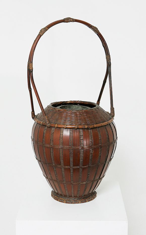 Bonhams : An oviform basket with typical reticulated design;