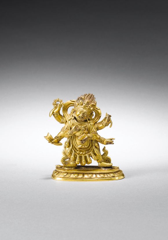 Bonhams : A small gilt-bronze figure of six-armed Dahei Tian 18th century