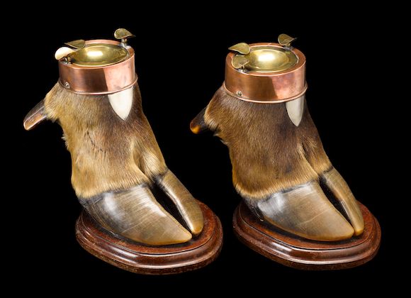 Bonhams : A pair of buffalo feet mounted with brass ash trays