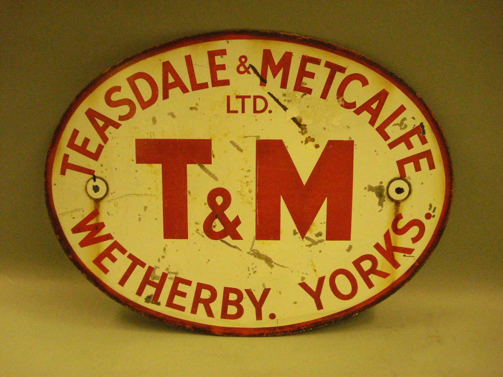 Bonhams Cars : A 'Teasdale & Metcalfe Ltd' oval enamel sign,
