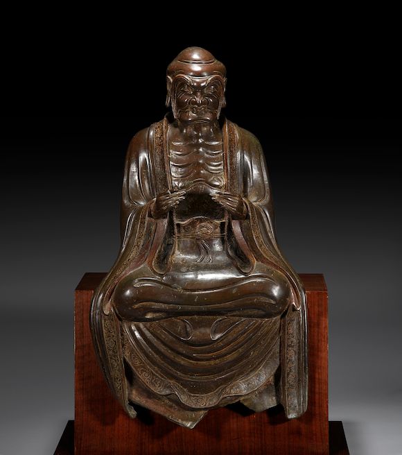 Bonhams : A large inscribed bronze figure of a seated luohan 14th century