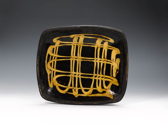 Bonhams : A Staffordshire slipware dish mid 18th century