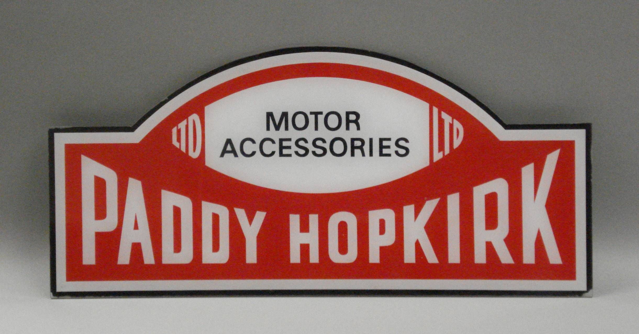 Bonhams Cars : A 'Paddy Hopkirk Ltd Motor Accessories' Perspex sign,