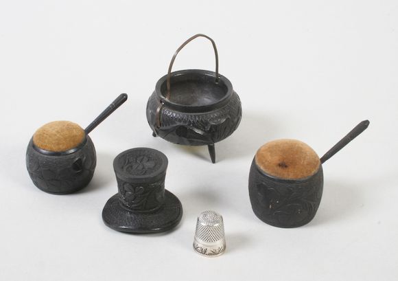 Bonhams : Three Irish bog oak pincushions and a similar thimble stand