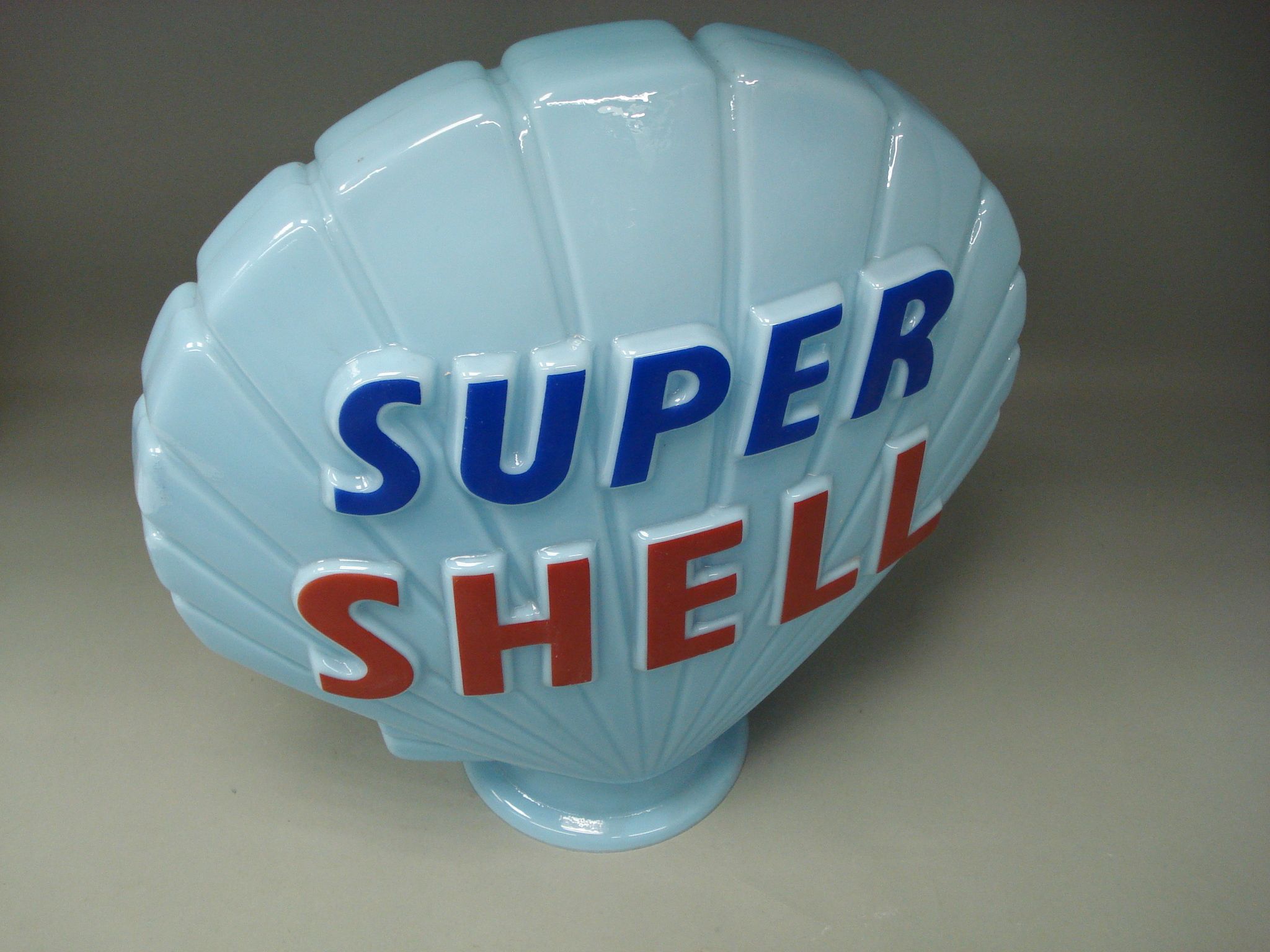 Bonhams Cars : A blue glass Shell Super petrol pump globe,