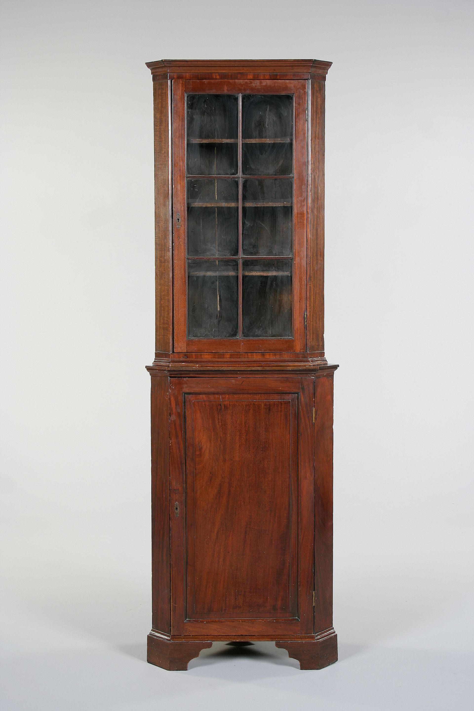 Bonhams : A mahogany double height corner cupboard