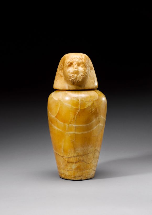 Bonhams : A large Egyptian banded alabaster canopic jar