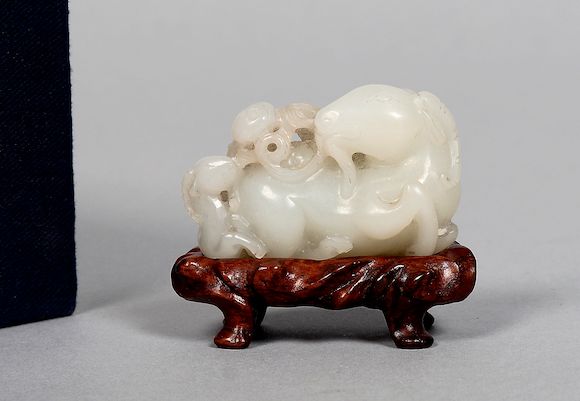Bonhams : A Chinese carved jade figure of two goats and a peach