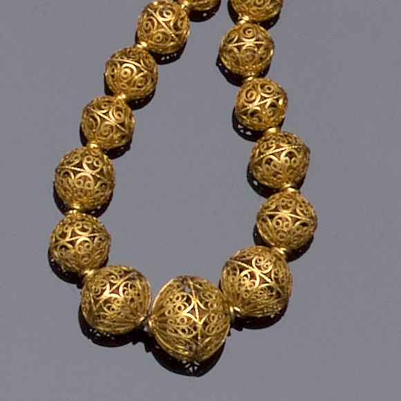 Bonhams : A filigree bead necklace,
