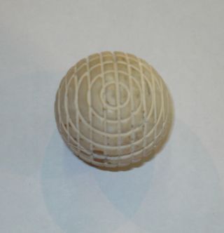 Bonhams : A carved lined four pole wooden golf ball
